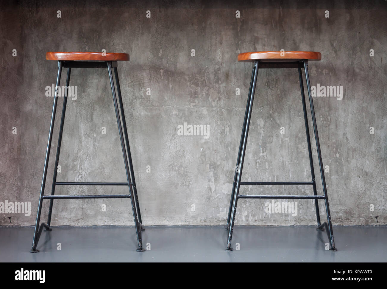 Elegant chairs with empty concrete background Stock Photo - Alamy