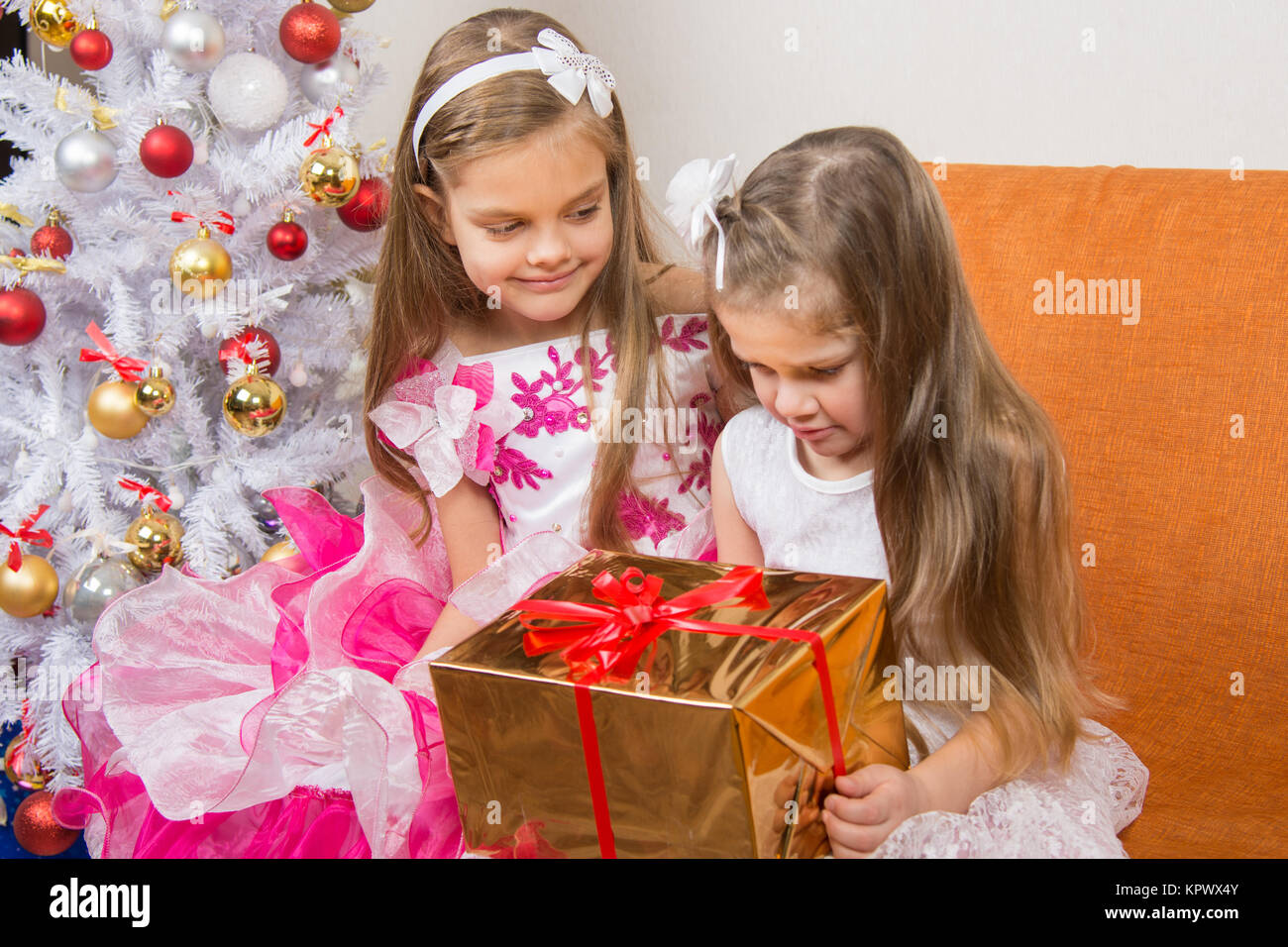 Girl encourages another girl who gave the wrong gift Stock Photo - Alamy