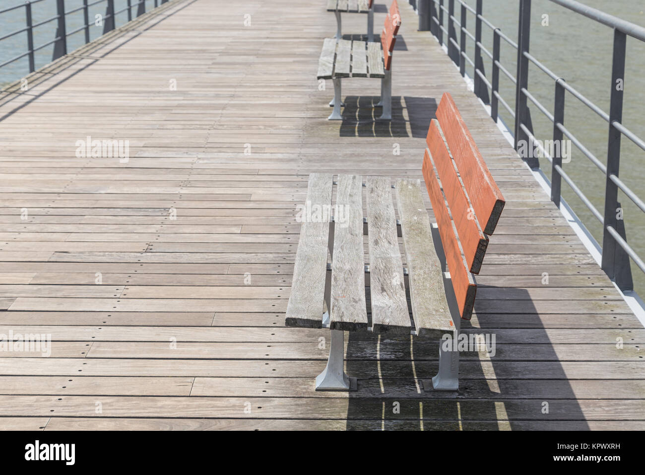 empty wooden bench on footbridge Stock Photo - Alamy