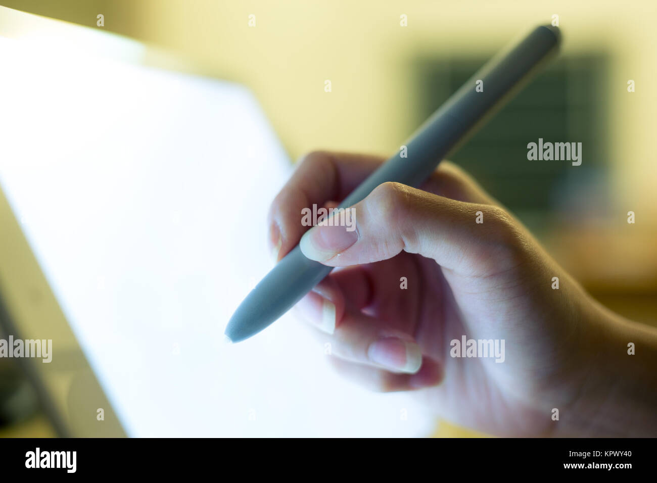 Hand holding a pen touching screen on modern digital tablet Stock Photo ...