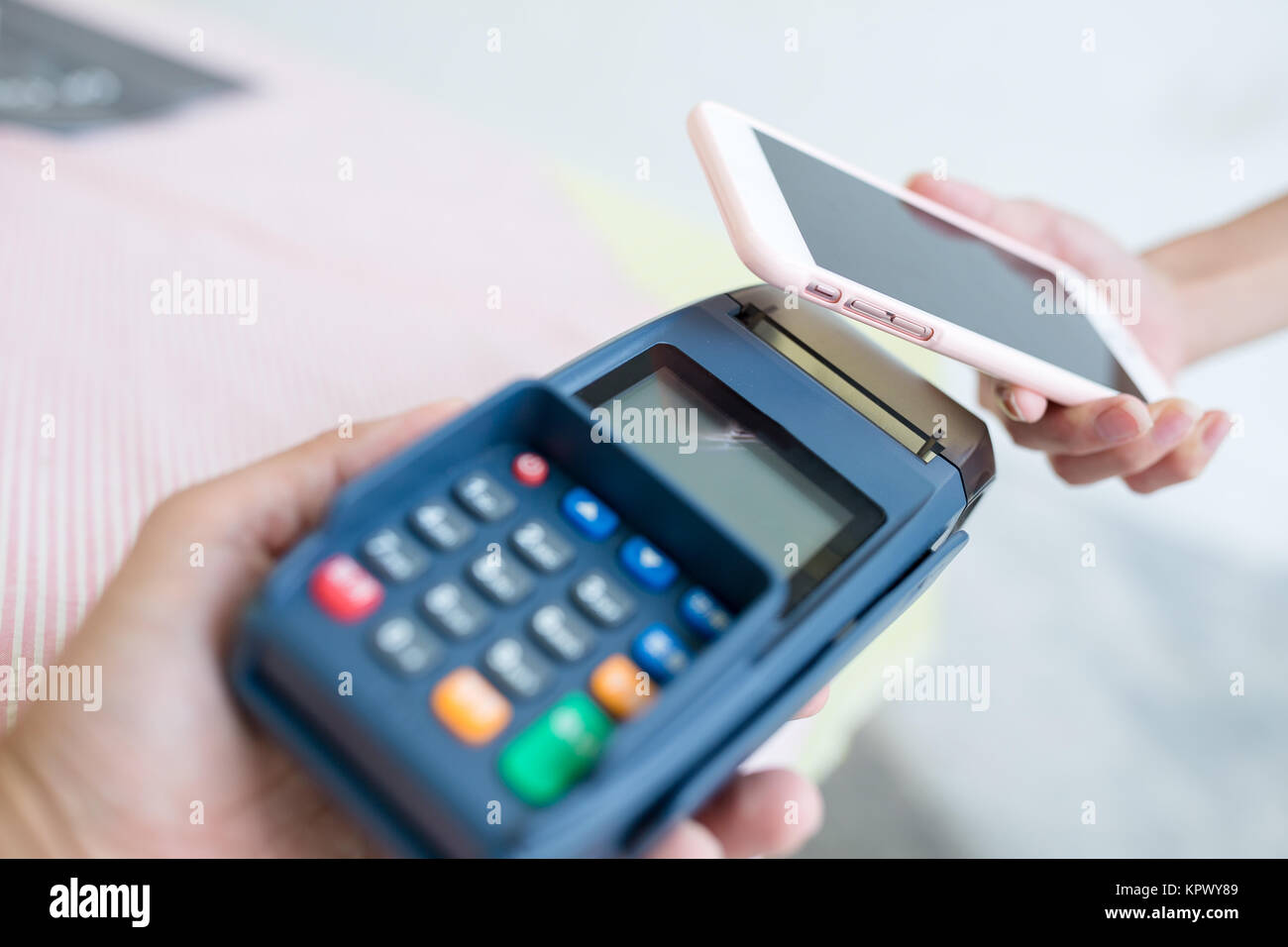 Woman making payment through smartphone Stock Photo - Alamy