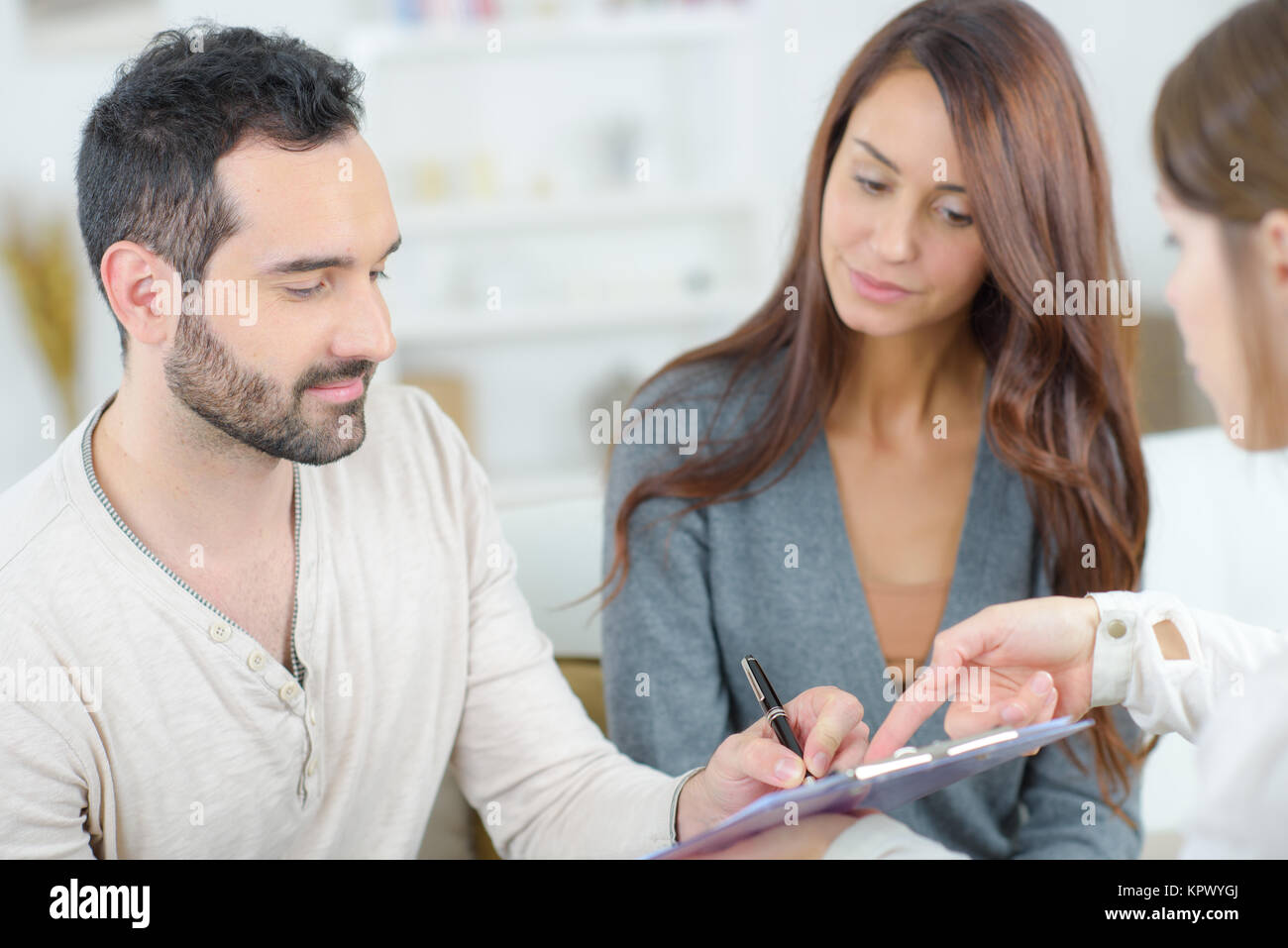 couple signing form Stock Photo - Alamy