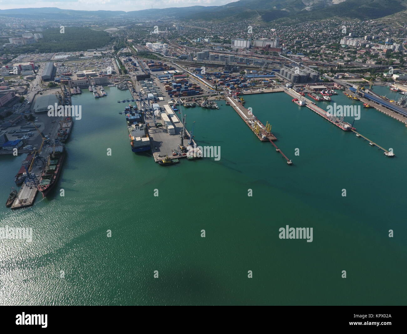 Industrial seaport, top view. Port cranes and cargo ships and barges ...