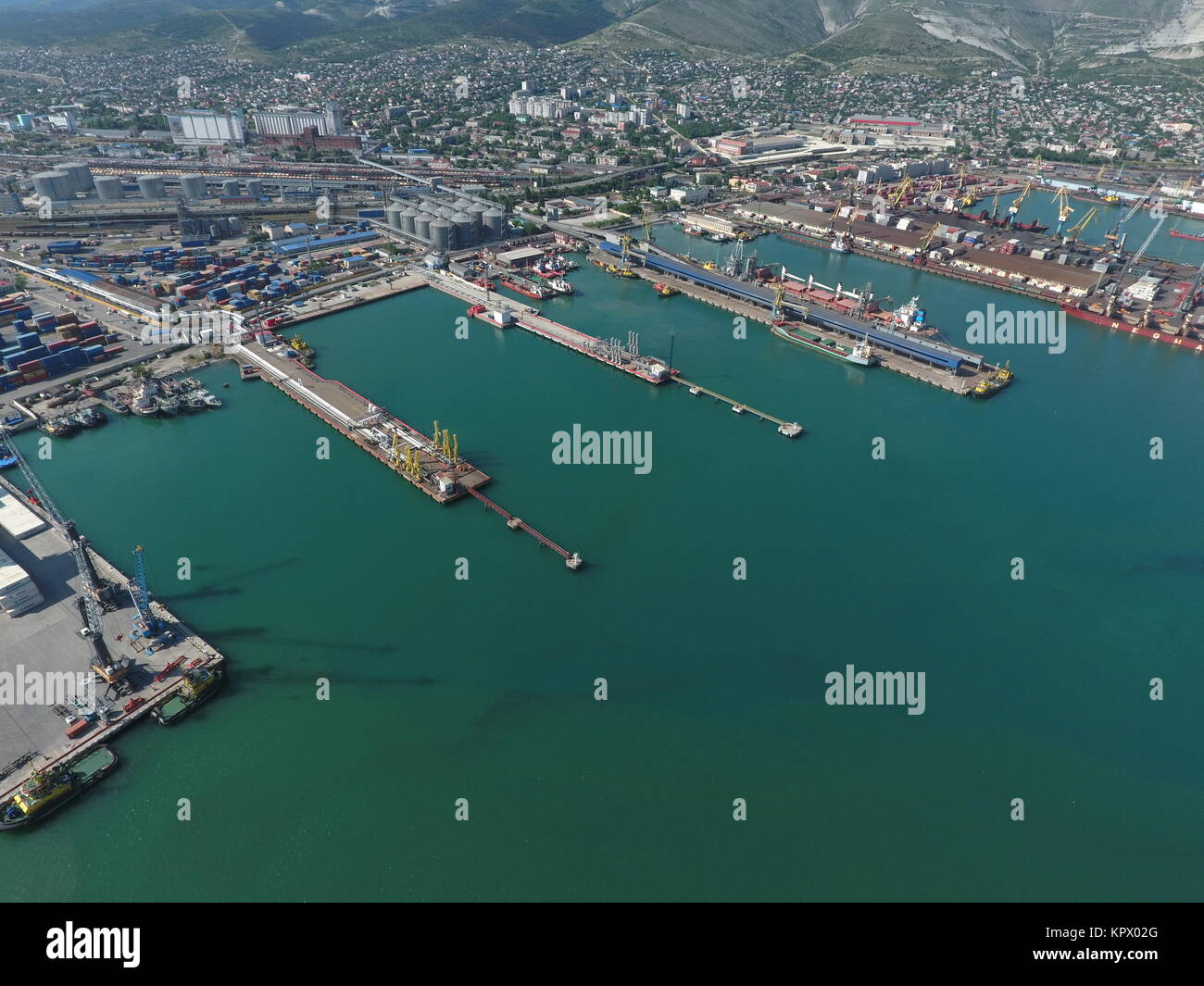 Industrial seaport, top view. Port cranes and cargo ships and barges ...