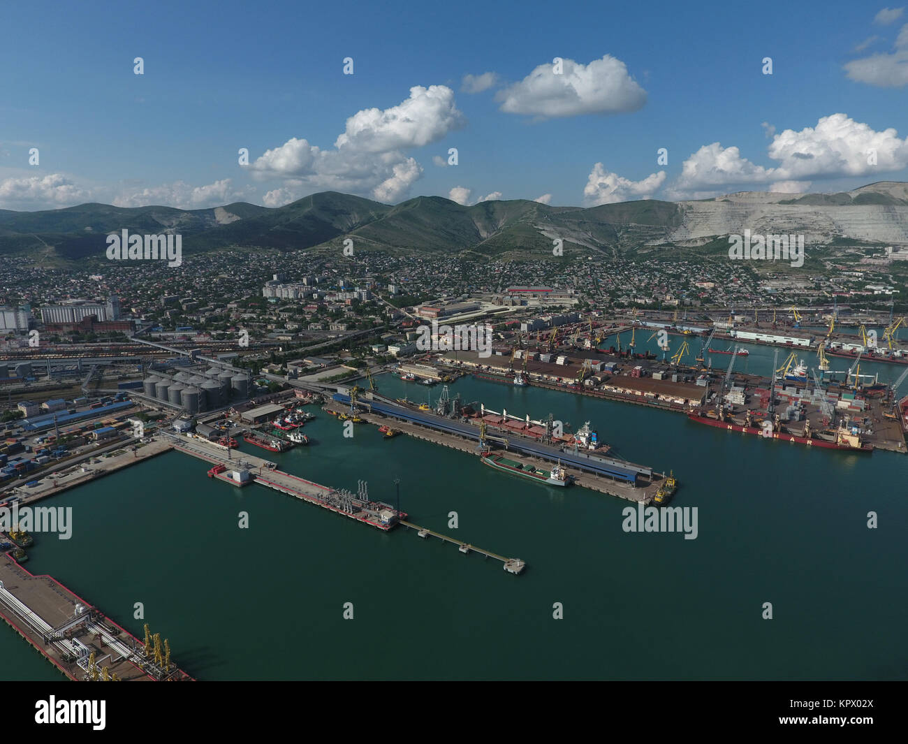 Industrial seaport, top view. Port cranes and cargo ships and barges ...