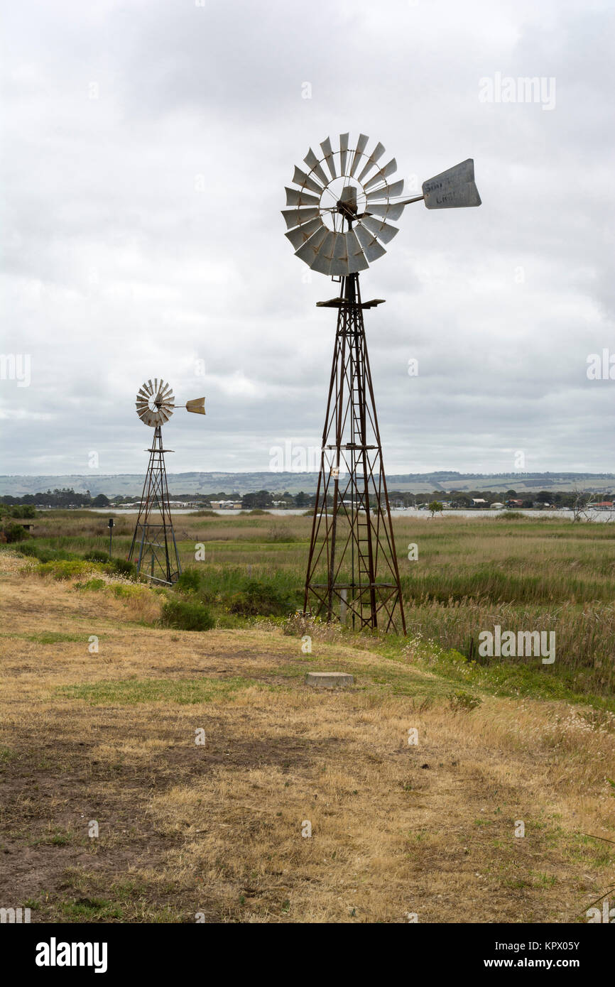 Metal windmills using wind power to bring river water to the houses ...