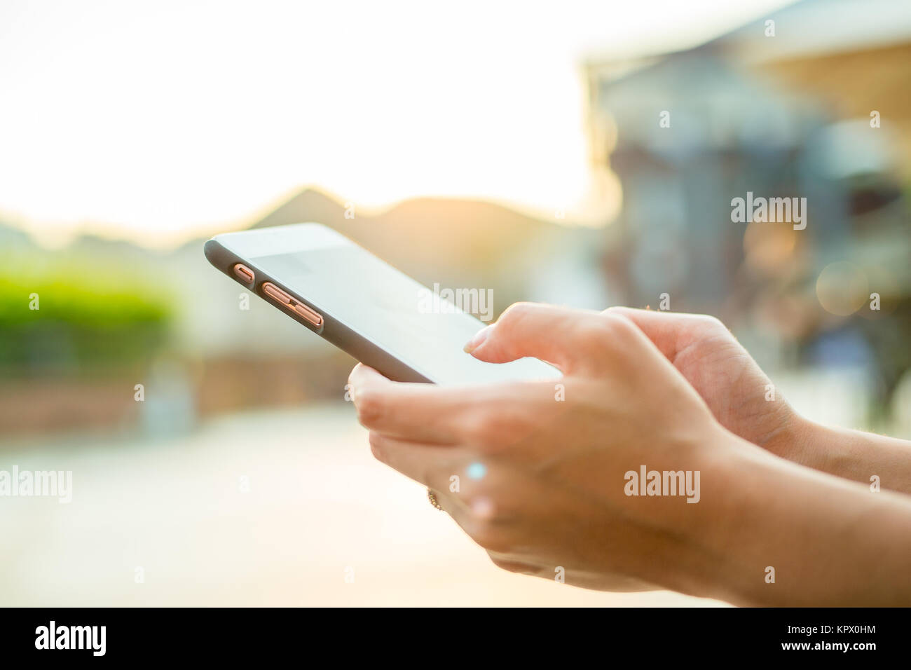 Woman use of cellphone at outdoor Stock Photo - Alamy