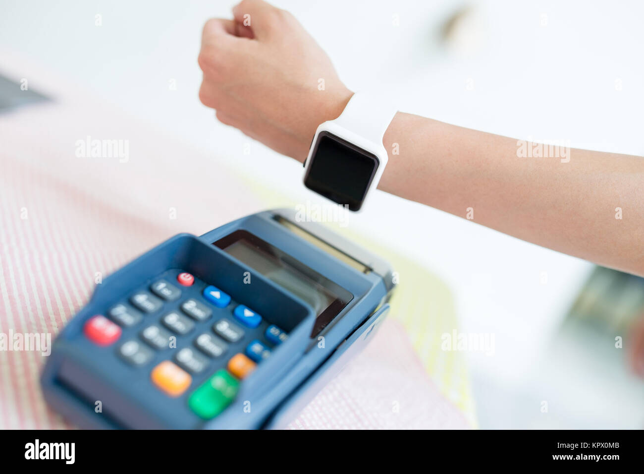 Woman using her smart watch to pay Stock Photo - Alamy