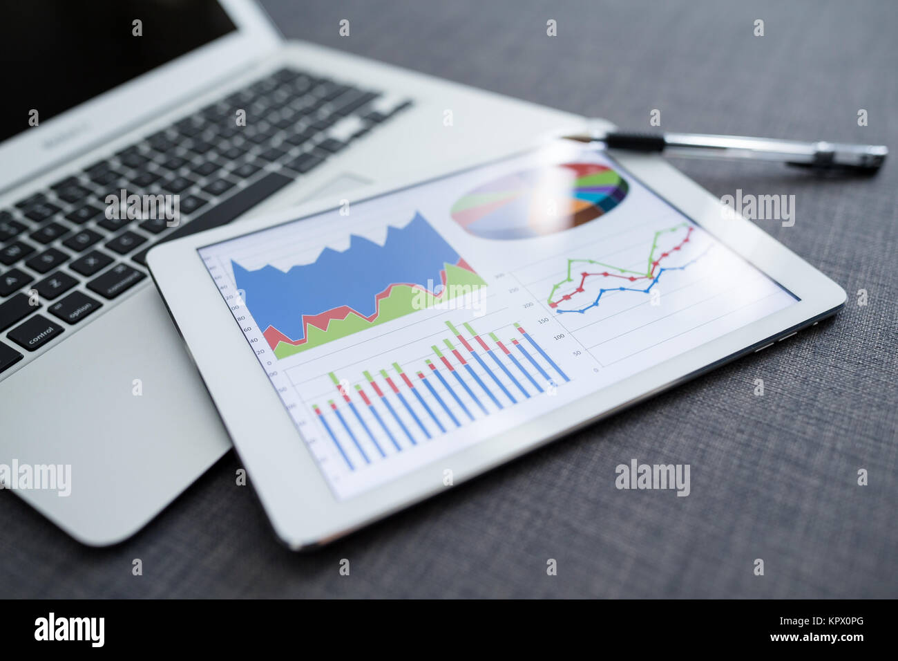 Digital tablet showing charts and diagram Stock Photo - Alamy