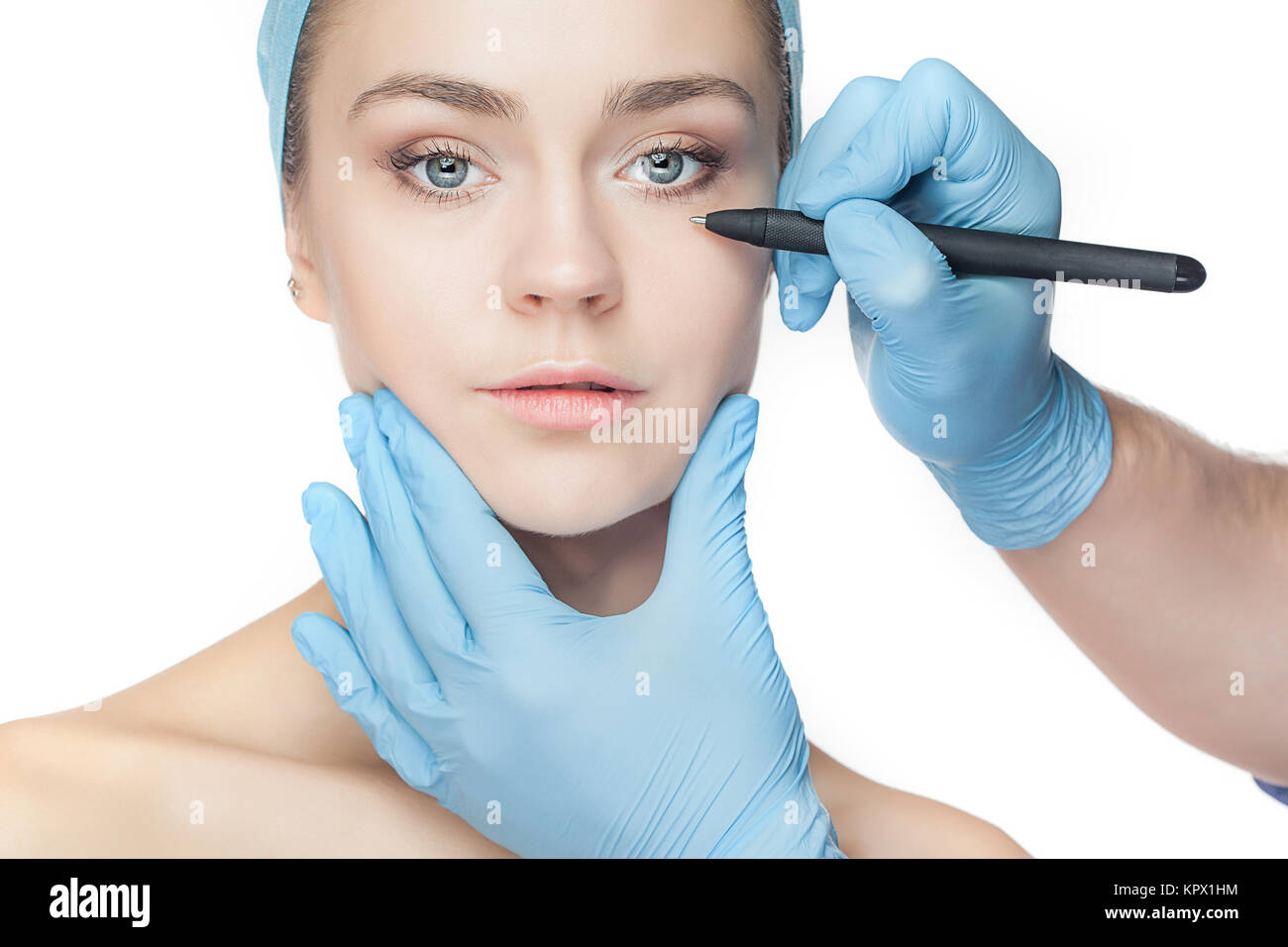 Beautiful young woman with perforation lines on her face before plastic ...