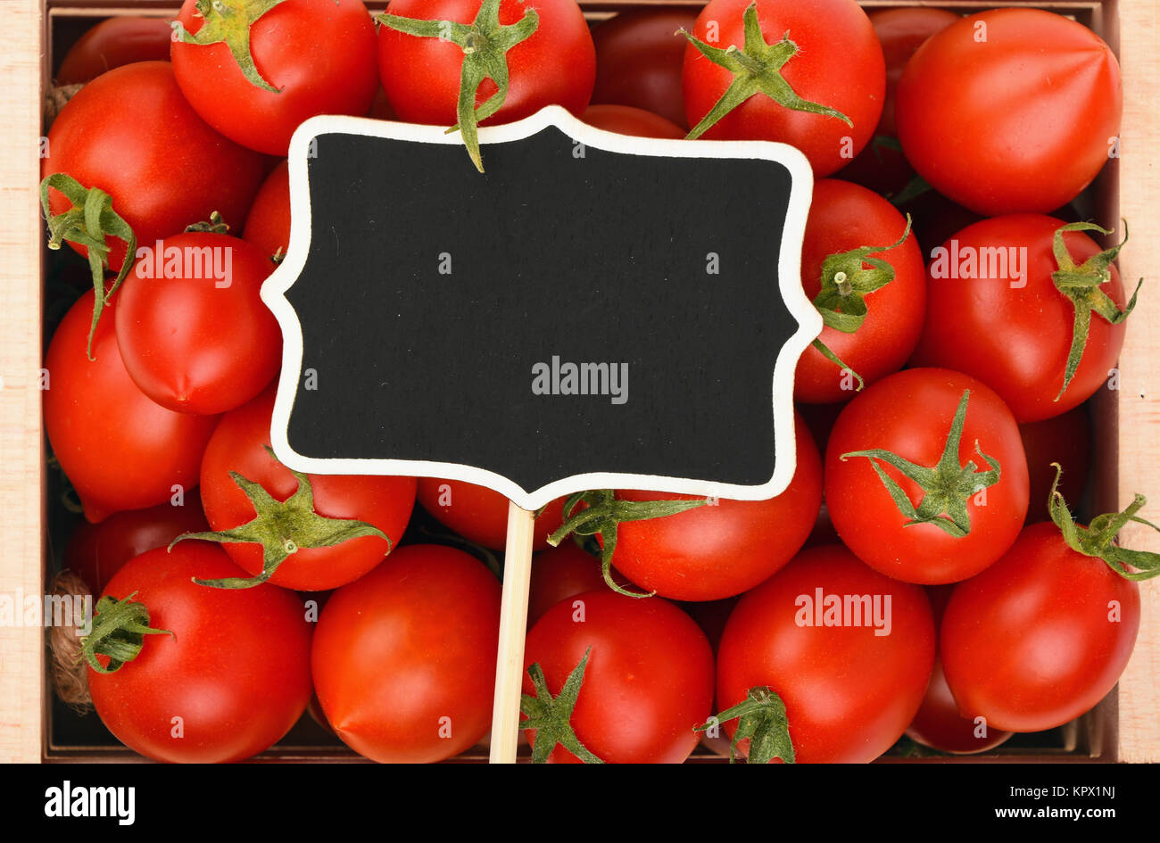 Red cherry tomatoes with black price sign Stock Photo - Alamy