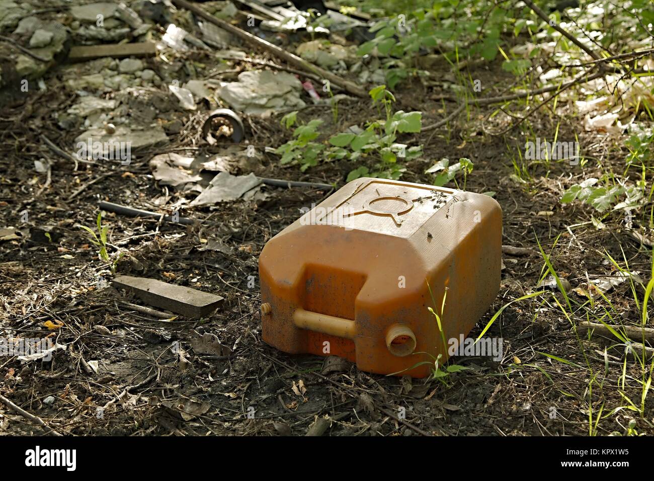 Oil can on the ground Stock Photo - Alamy