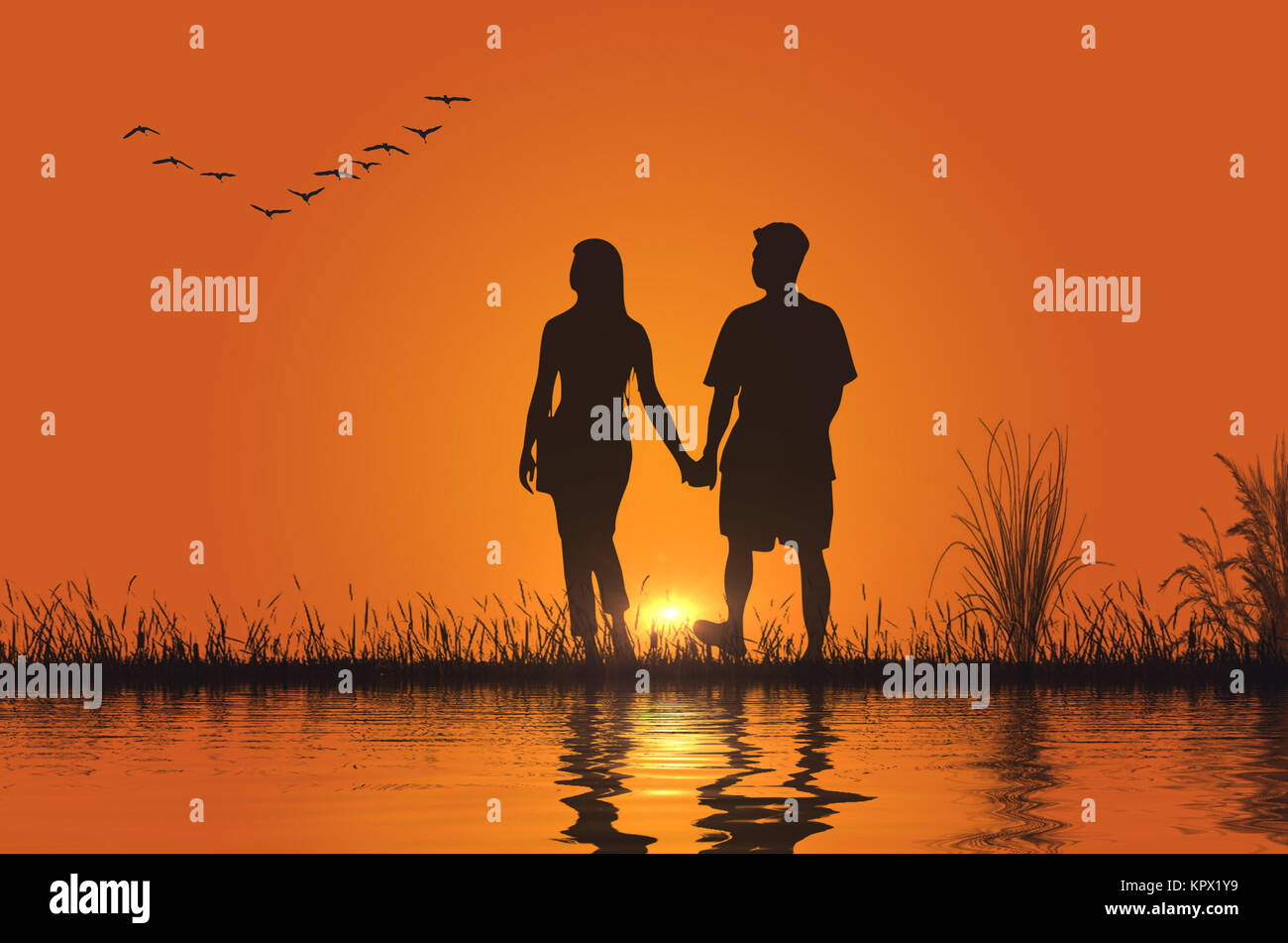 Couple at sunset Stock Photo - Alamy