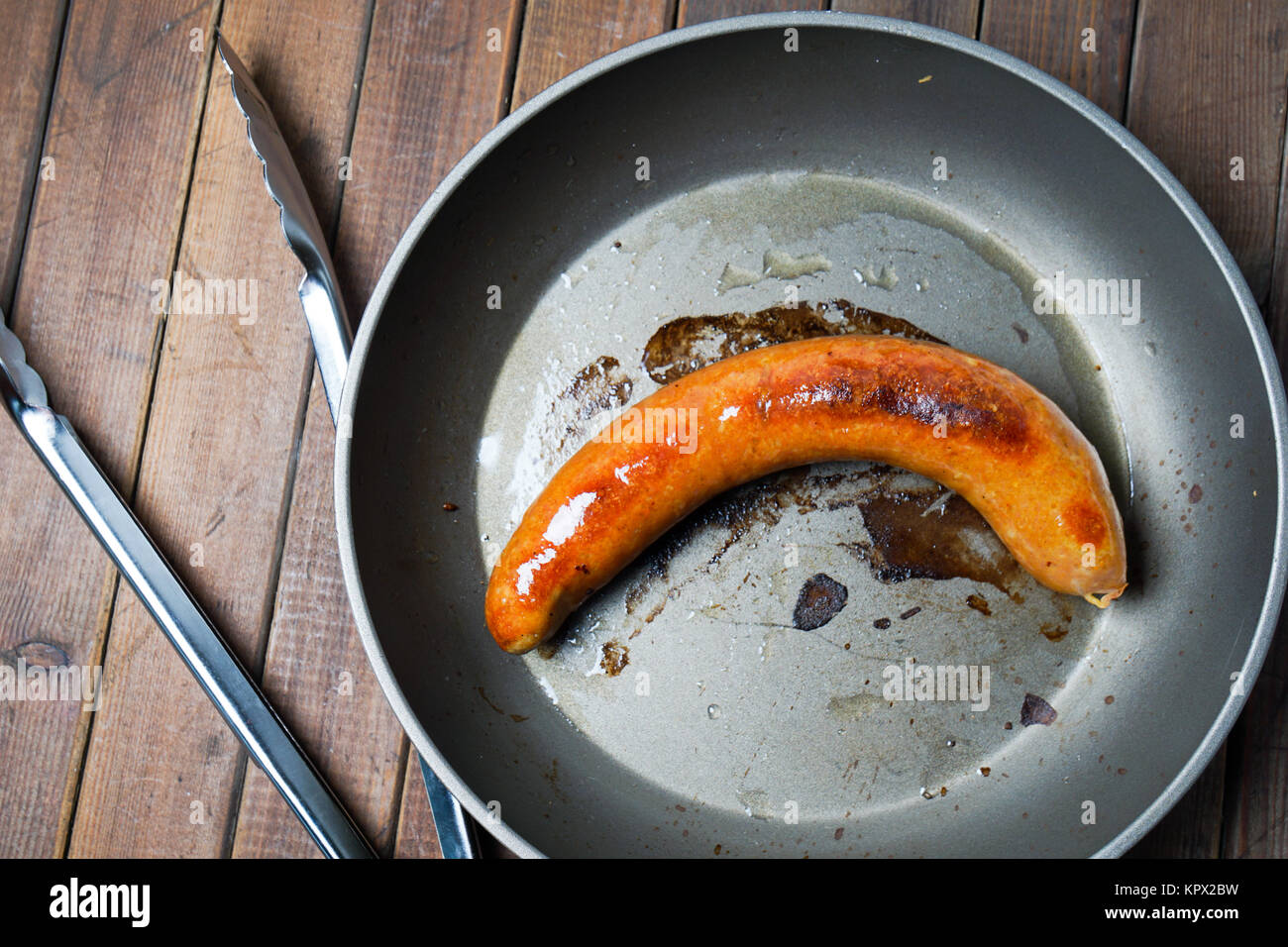 One fried sausage on the skillet Stock Photo - Alamy
