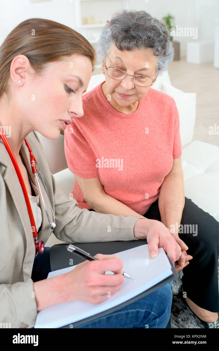 Doctor writing a prescription for a senior patient Stock Photo - Alamy