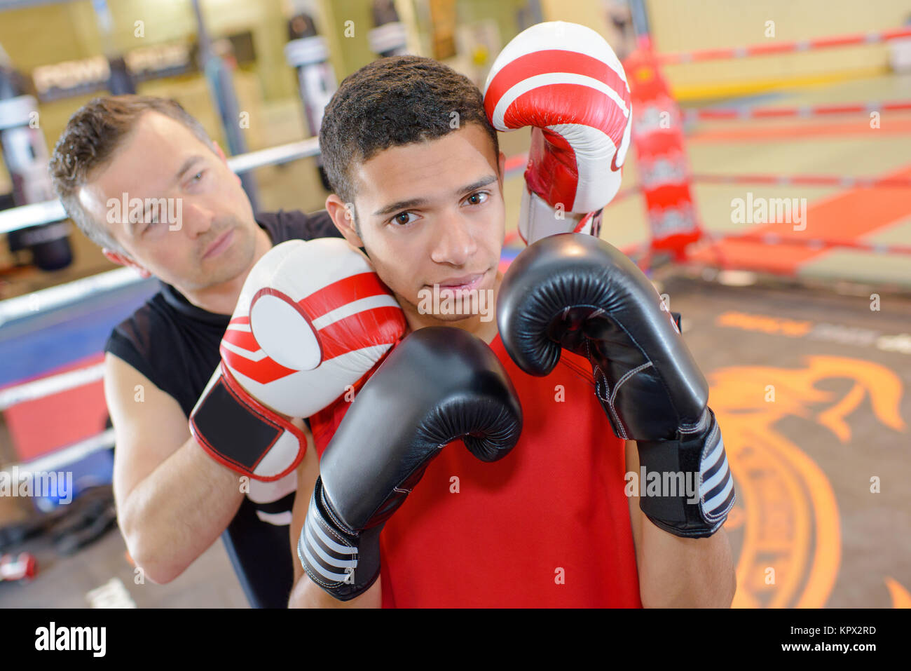 Young man with boxing instructor Stock Photo - Alamy