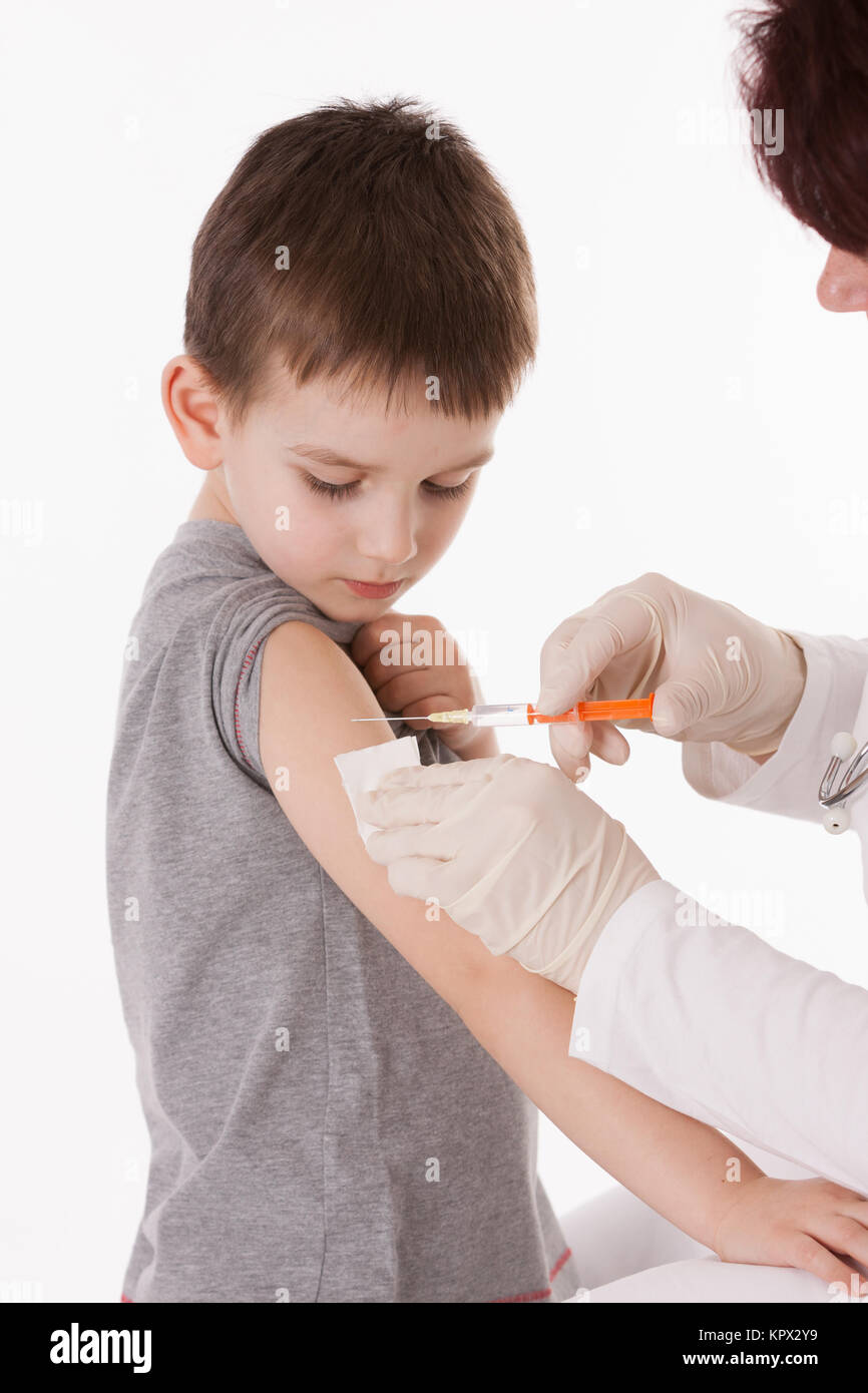 Doctor giving a child injection in arm on isolated image Stock Photo ...