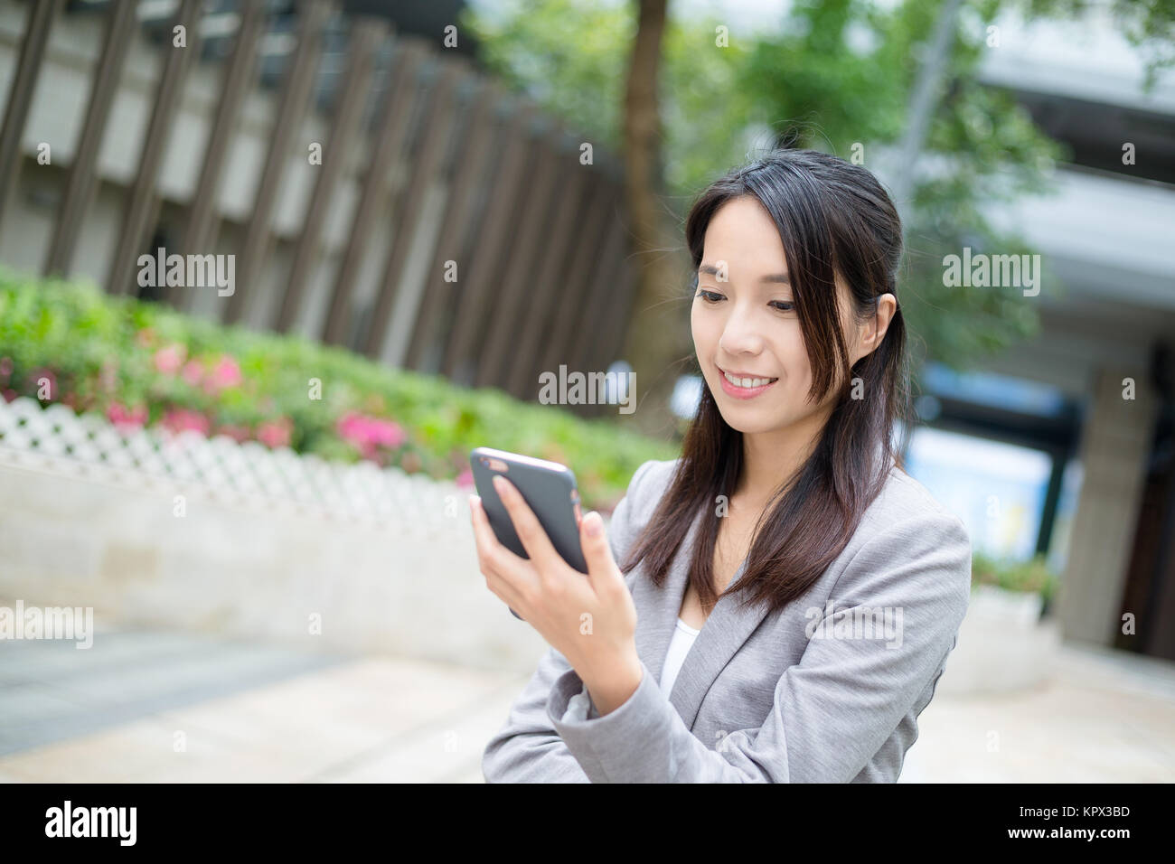 Business woman use of mobile phone Stock Photo - Alamy