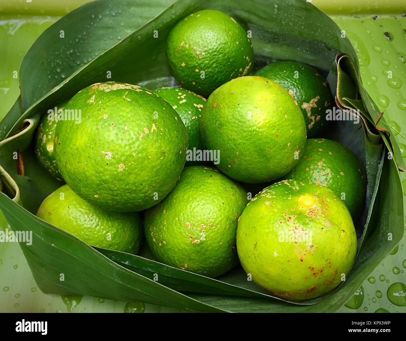 Fresh Limes In Banana Leaf Packaging Stock Photo - Alamy