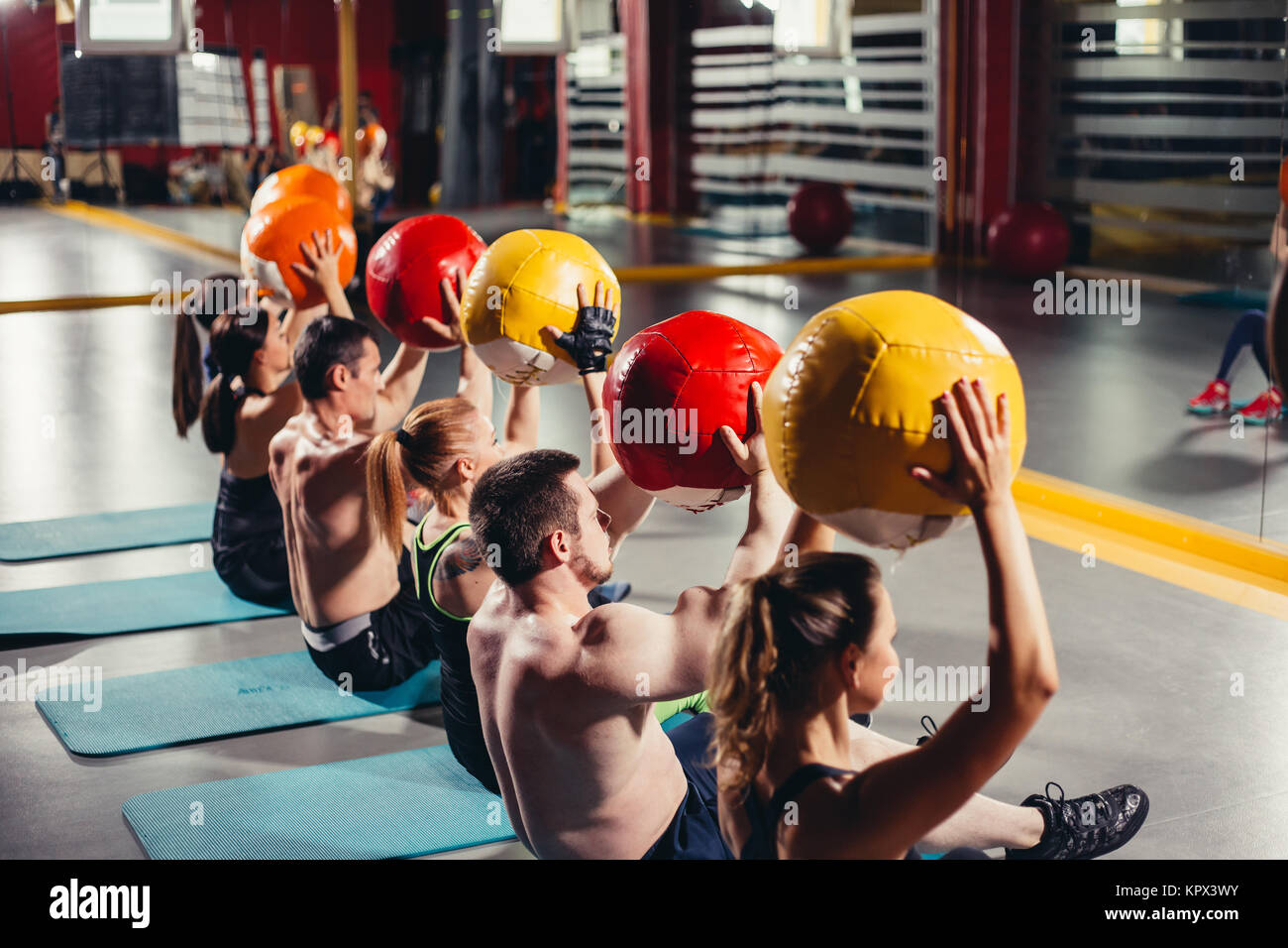 People exercising with pilates ball at gym Stock Photo - Alamy