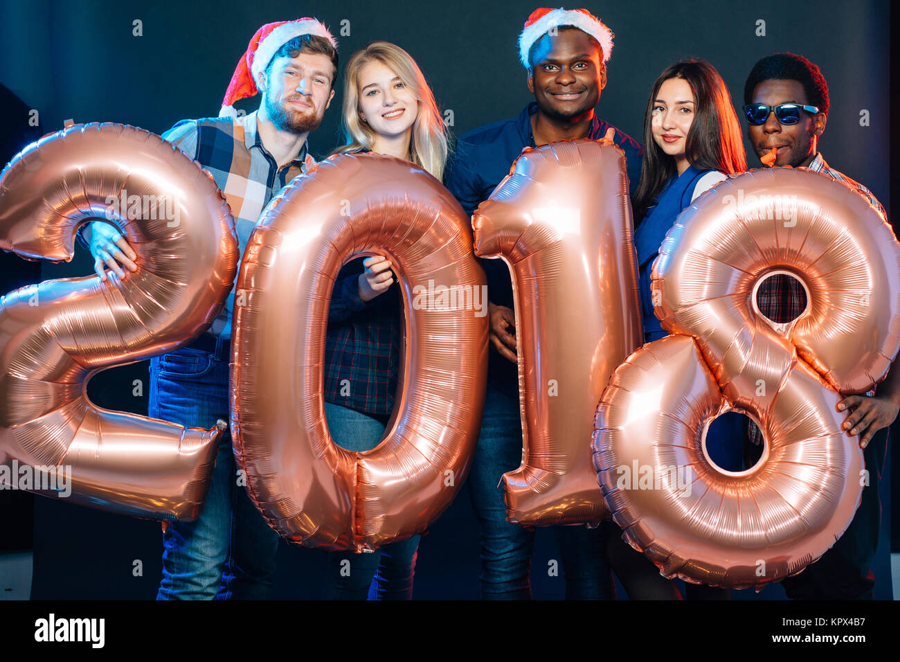 Happy smiling people holding golden number balloons, 2018 year symbol ...