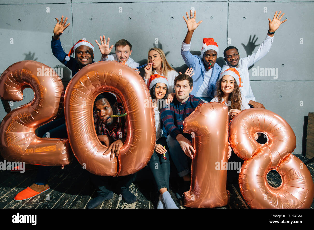Happy smiling people holding golden number balloons, 2018 year symbol ...