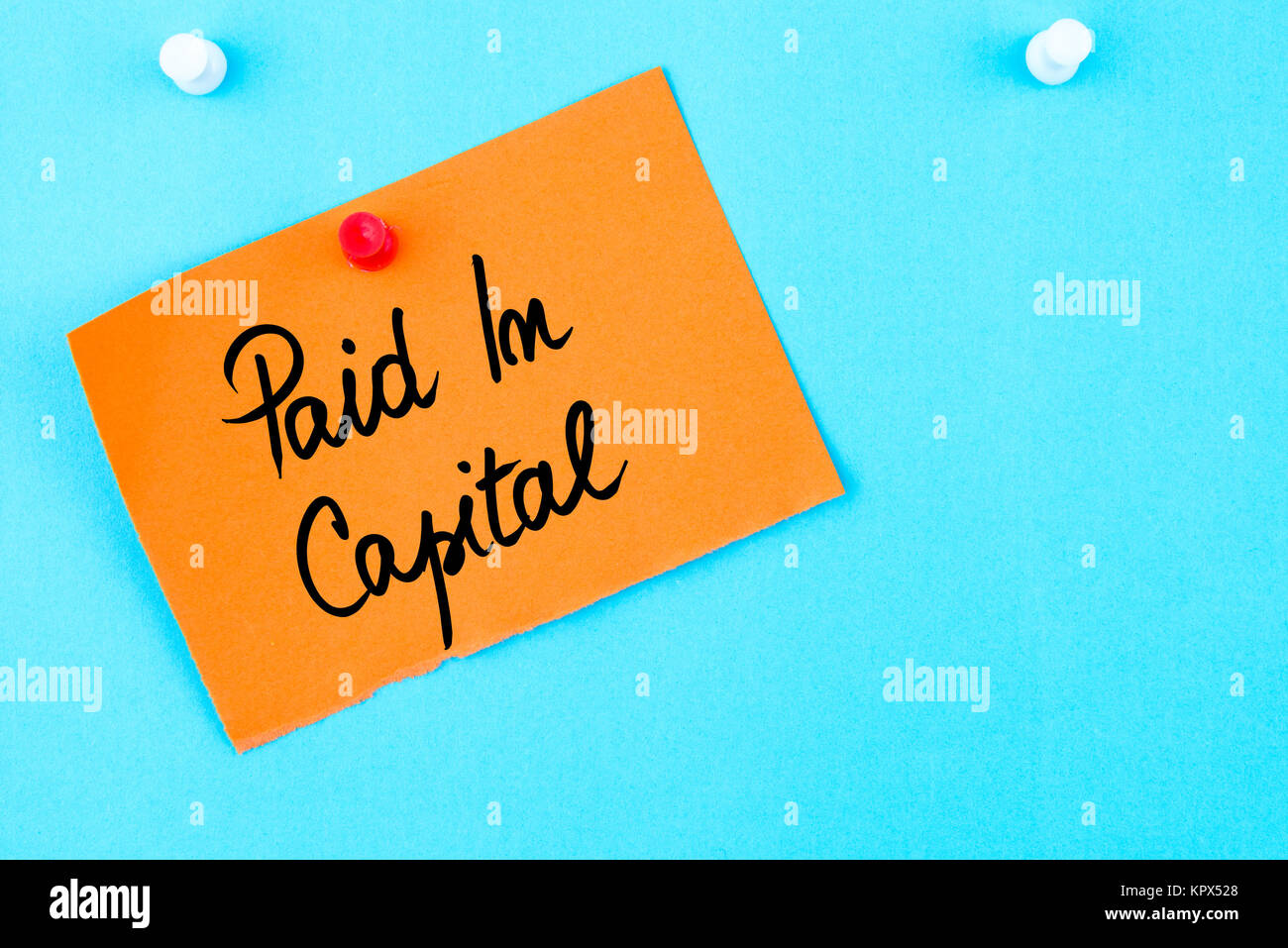 Paid In Capital written on orange paper note Stock Photo - Alamy