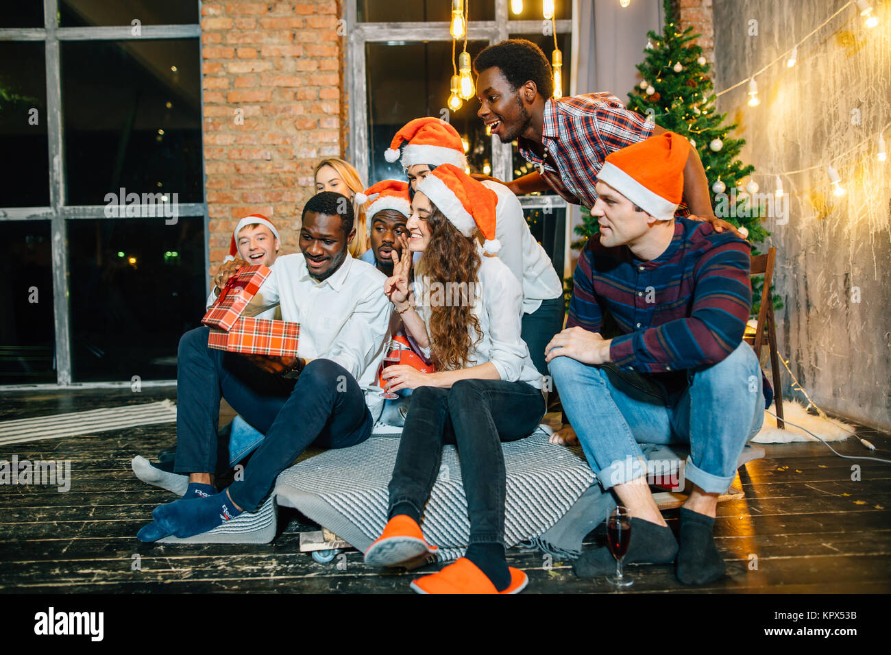 happy smiling friends opening magic Christmas gift Stock Photo - Alamy
