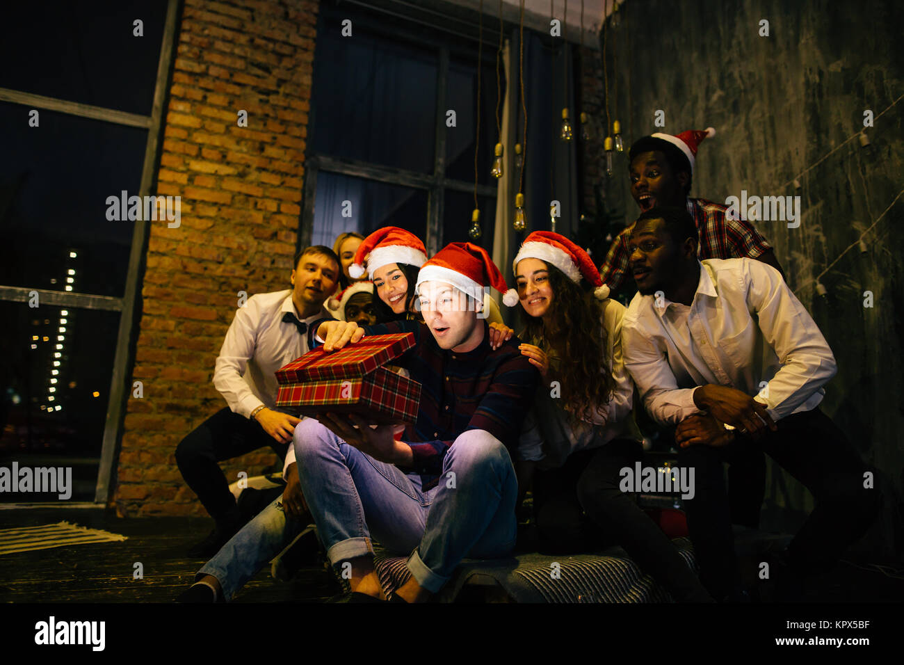happy smiling friends opening magic Christmas gift Stock Photo - Alamy