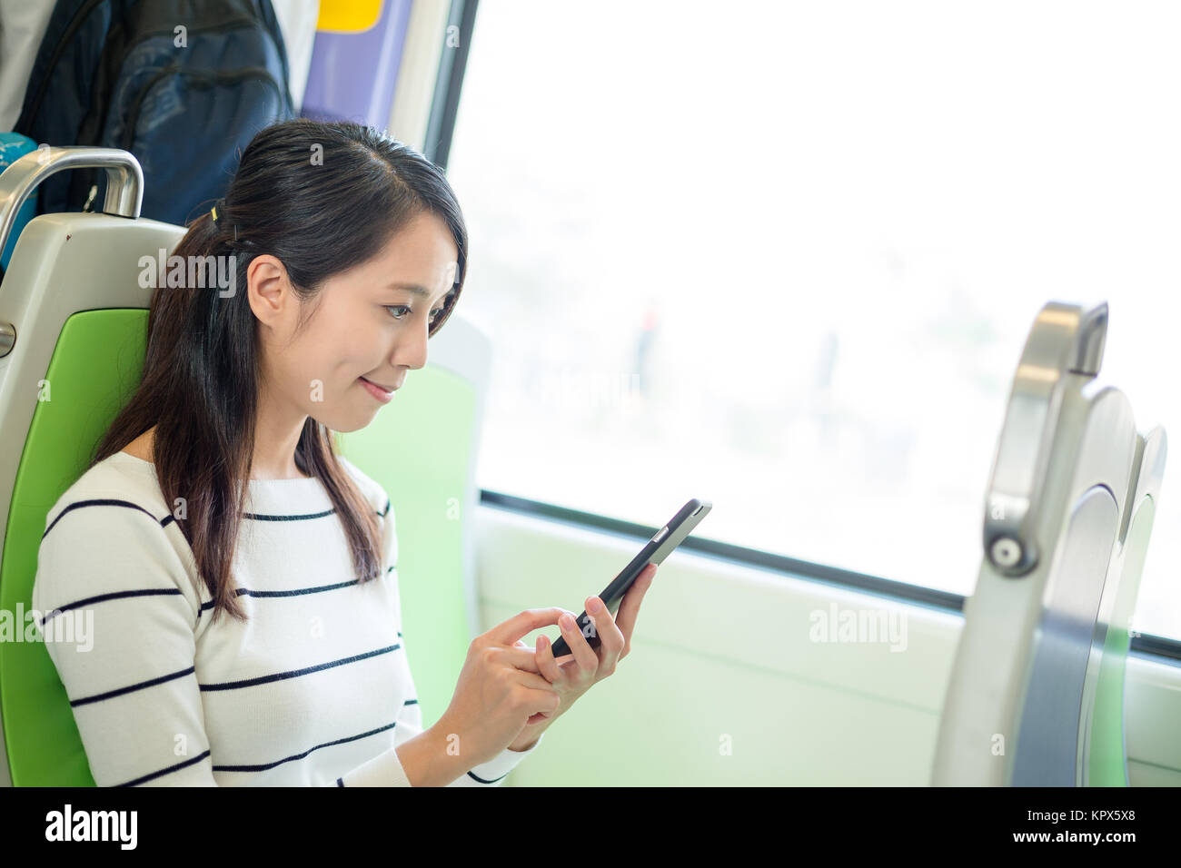 Woman use of cellphone inside train compartment Stock Photo - Alamy