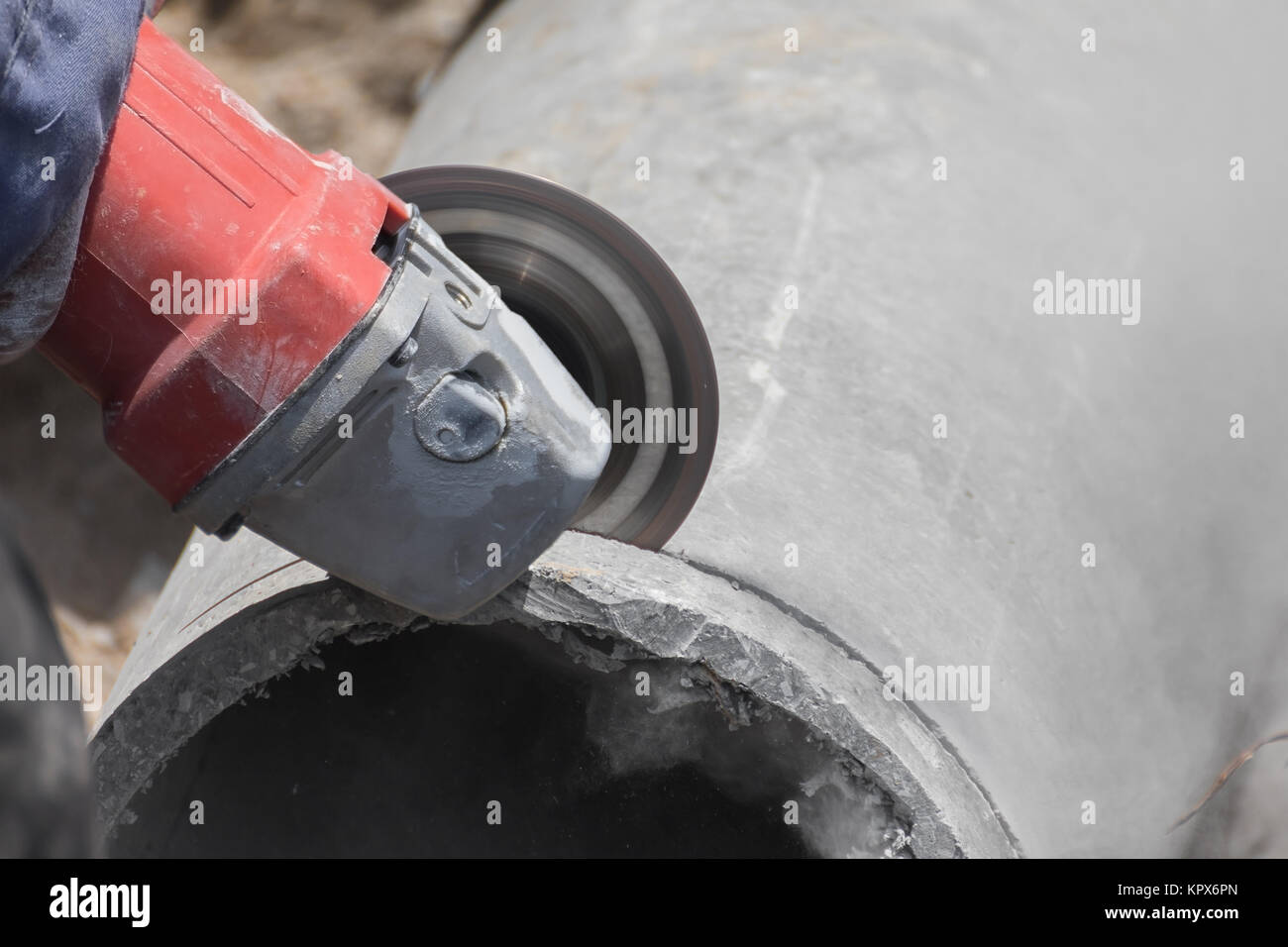 Plumbers cutting concrete water pipes Stock Photo - Alamy
