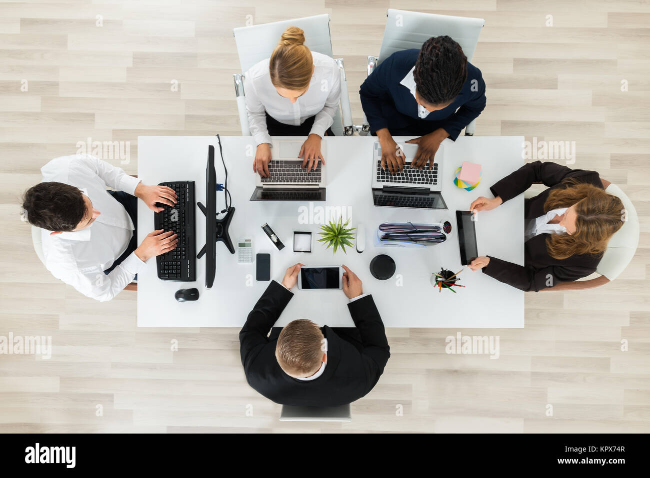 Businesspeople Working On Computers And Laptops Stock Photo - Alamy