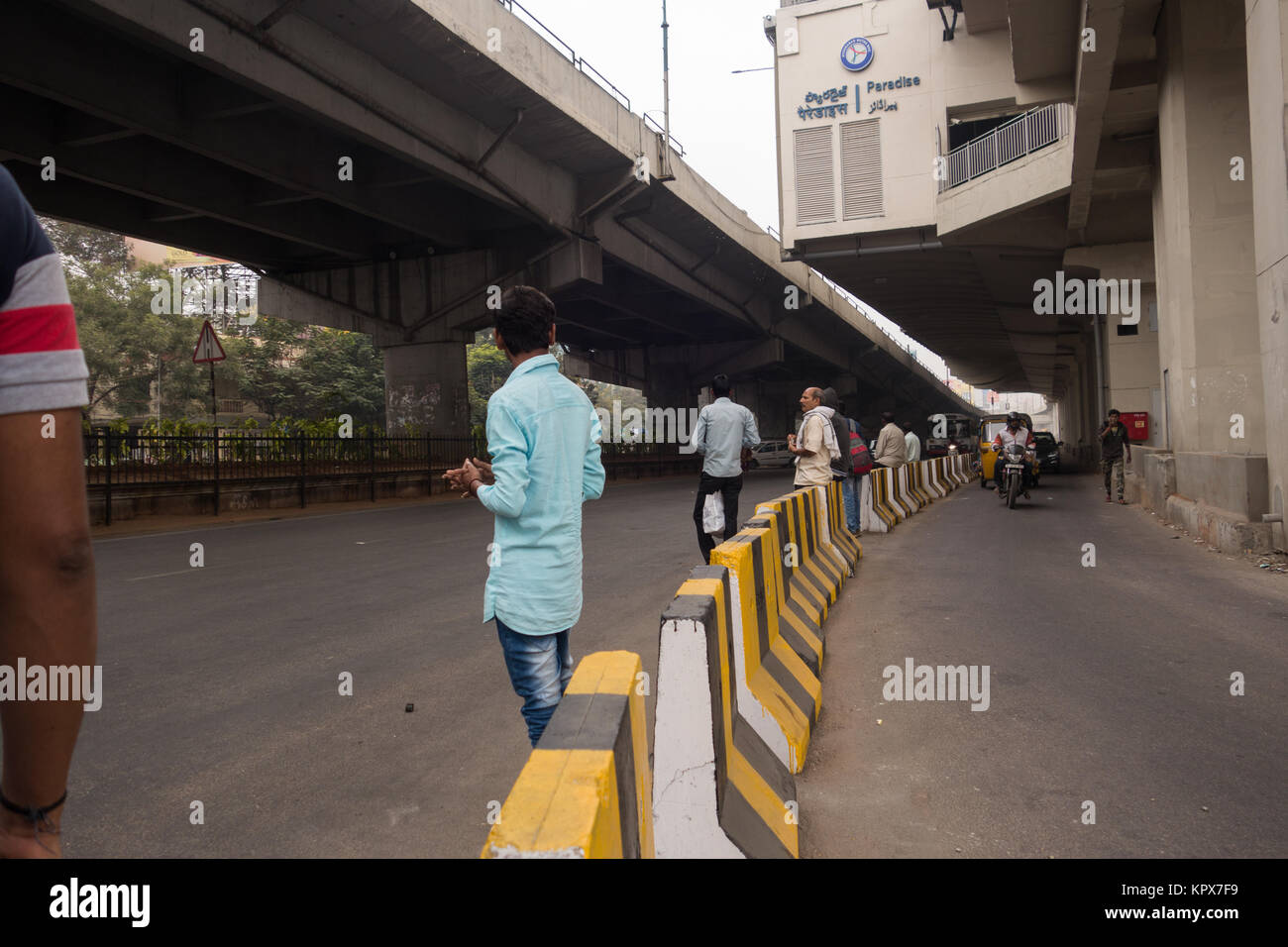 INDIA - CIRCA DECEMBER 2017 People wait for the bus at an intersection ...