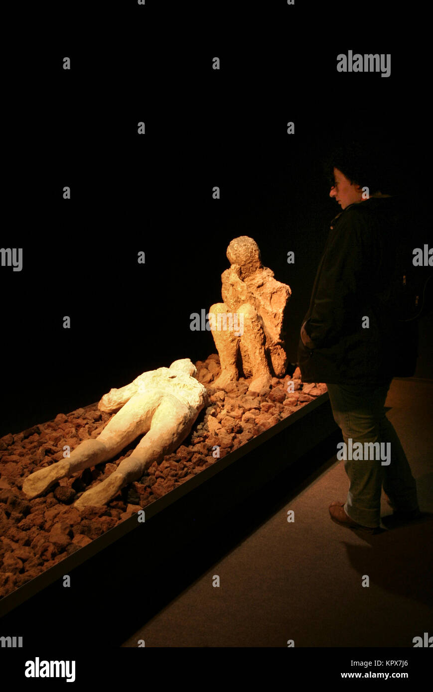 Visitor observing human victim body cast Stock Photo - Alamy