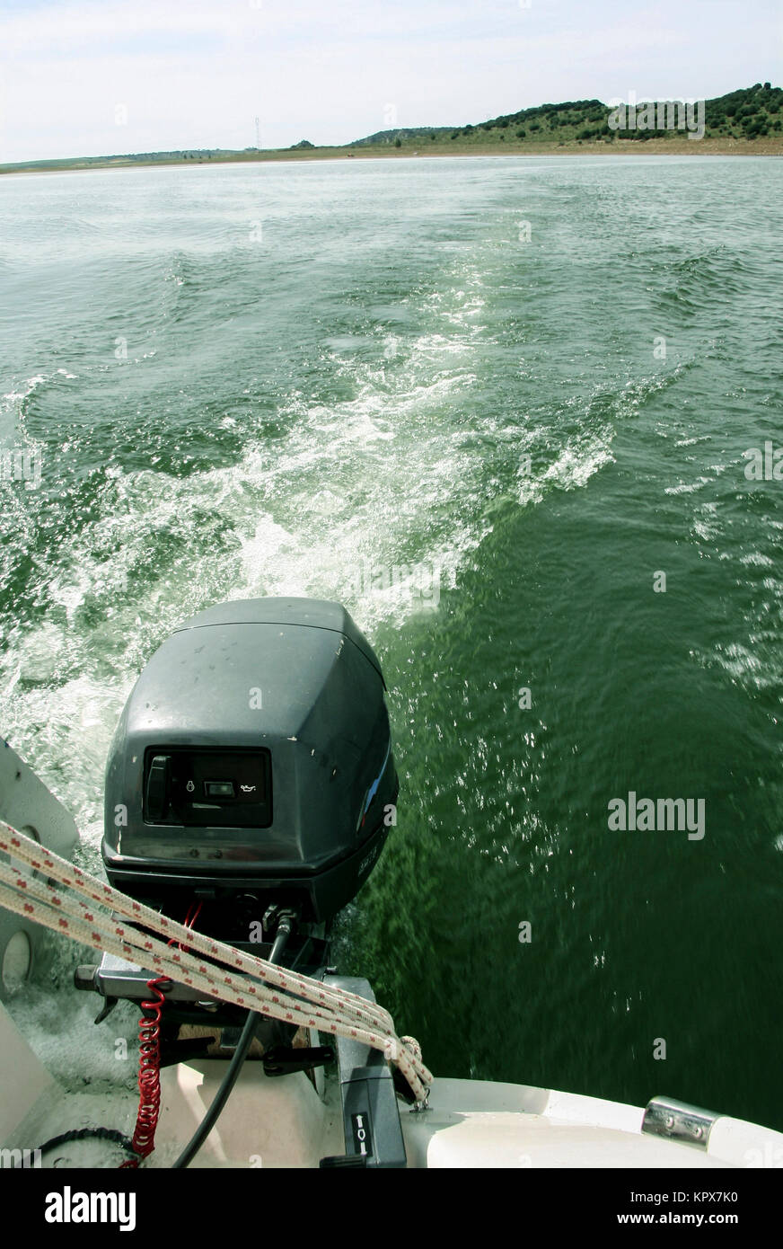 sailing across Alange Reservoir with outboard engine, Spain Stock Photo ...