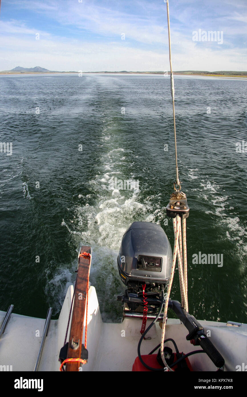 sailing across Alange Reservoir with outboard engine, Spain Stock Photo ...