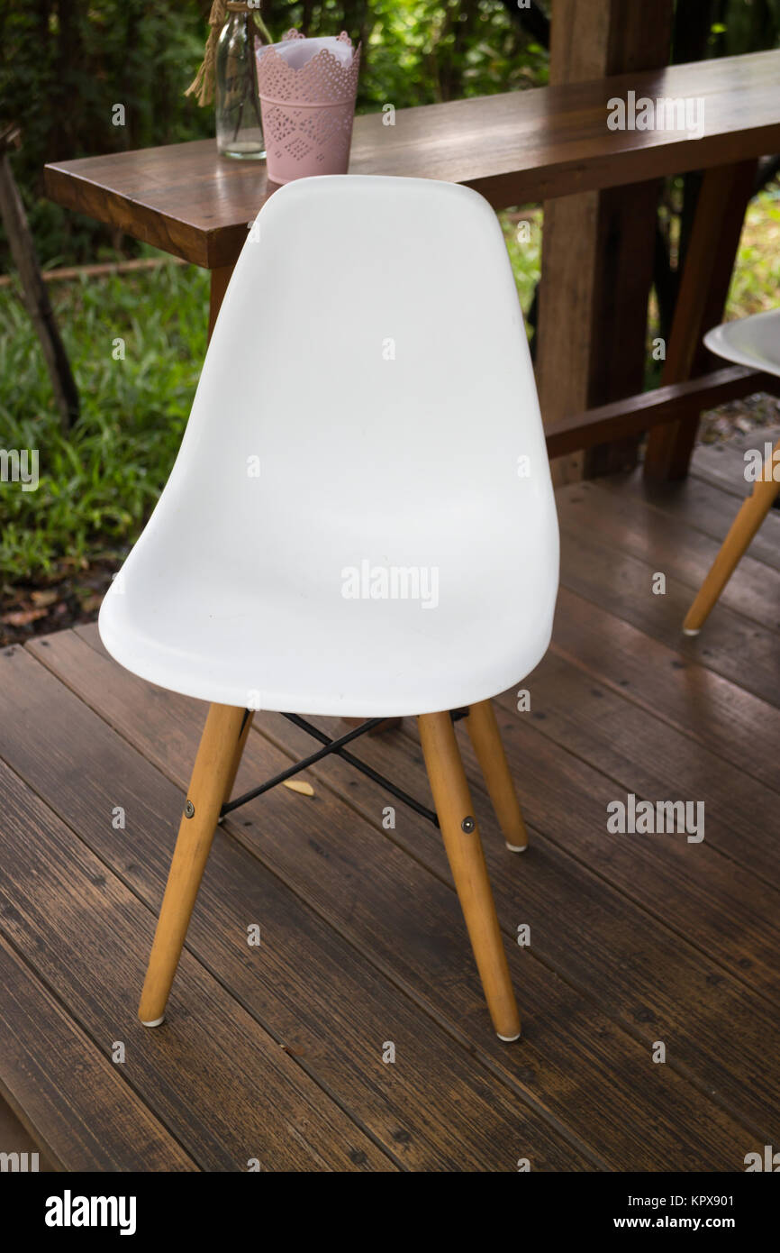 Wooden table and modern chair Stock Photo - Alamy