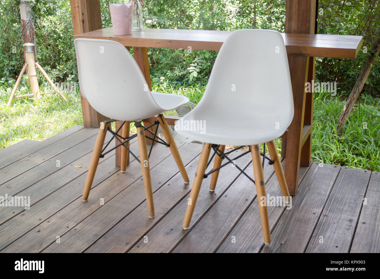 Wooden table and modern chair Stock Photo - Alamy