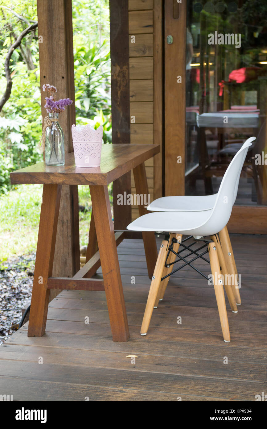 Wooden table and modern chair Stock Photo - Alamy