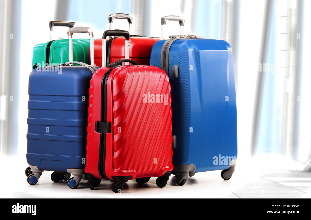 Five plastic suitcases isolated on white Stock Photo - Alamy