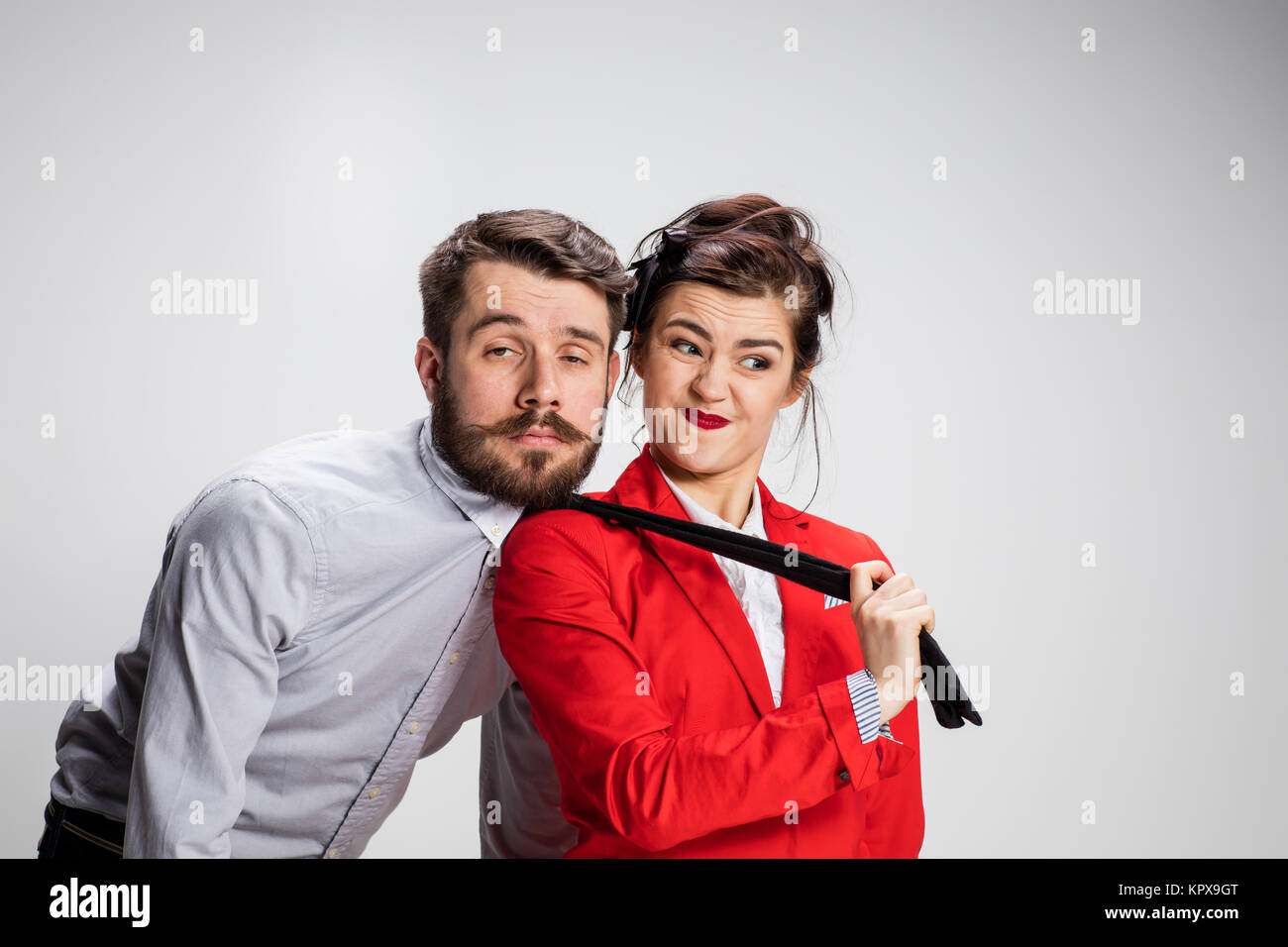 The business man and woman cooperating on a gray background Stock Photo ...