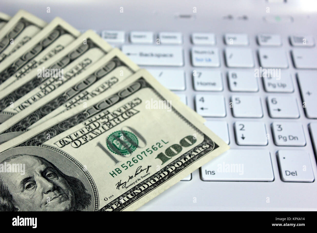 Dollars and computer Stock Photo - Alamy