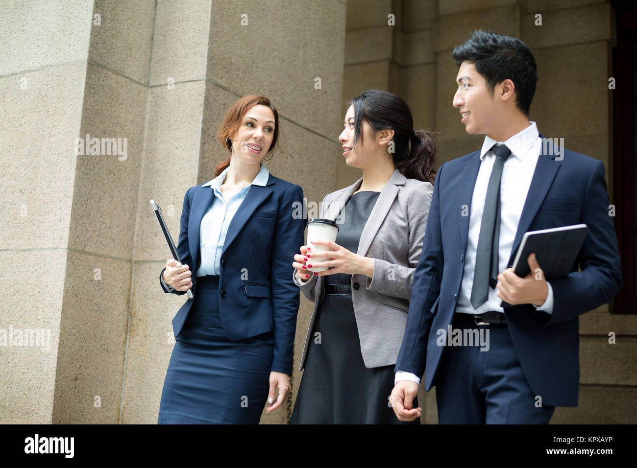 Group of business people walking out of office Stock Photo - Alamy