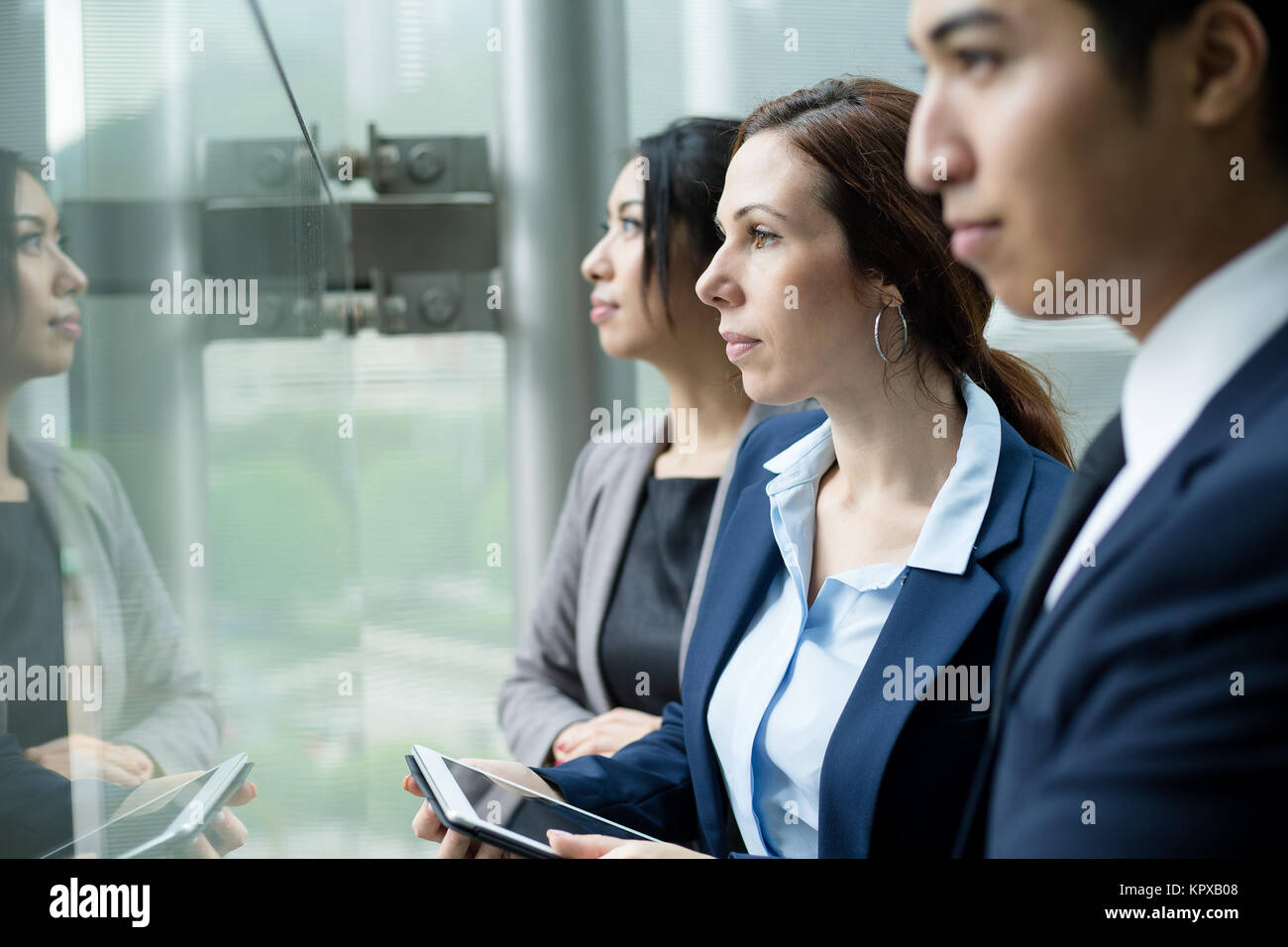 Business team looking out of window Stock Photo - Alamy