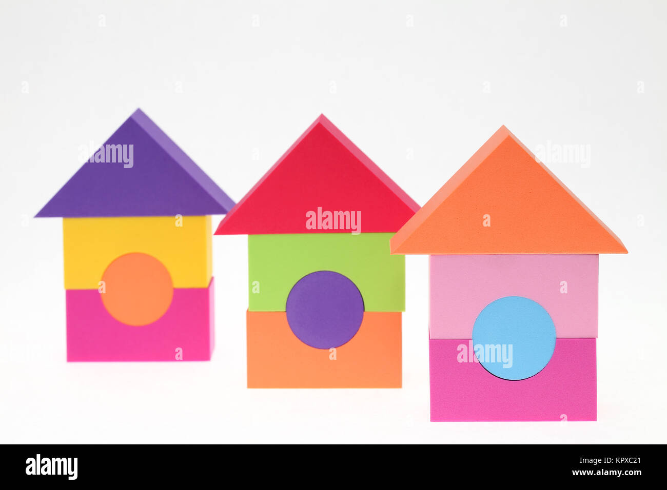 Toy house made of plastic bricks on white background Stock Photo - Alamy