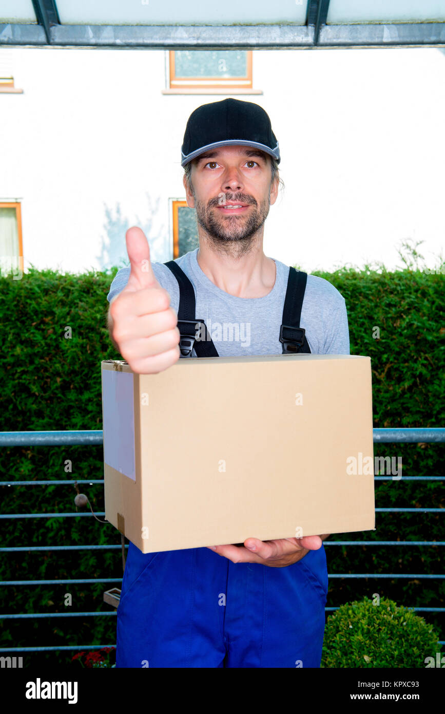 friendly postman with parcels in front of white background Stock Photo ...