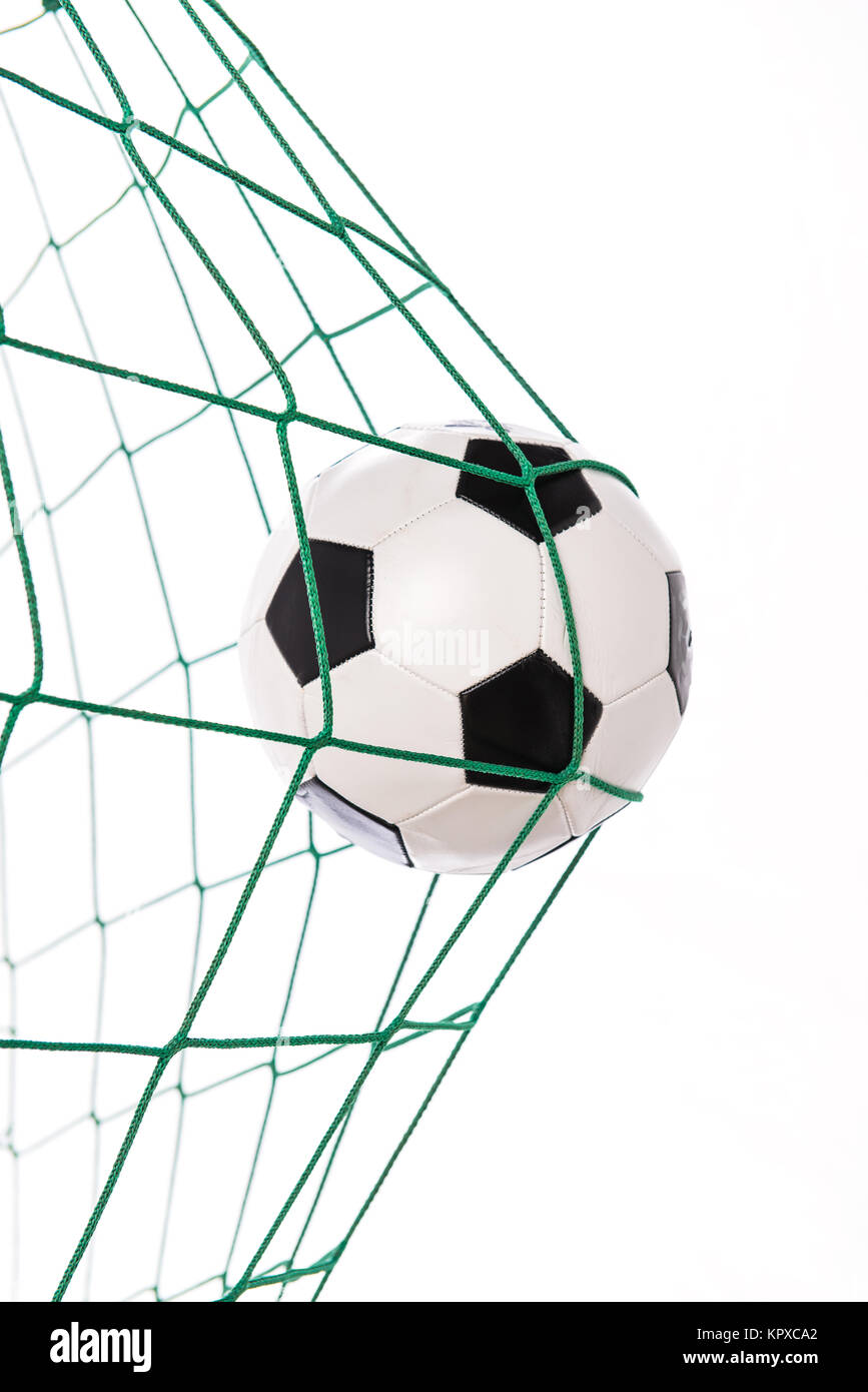 soccer ball in green goal in front of white background Stock Photo - Alamy