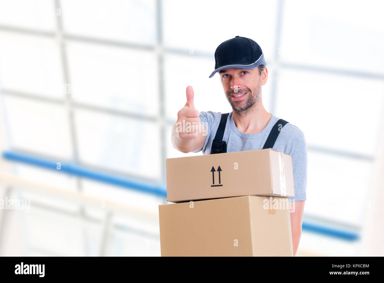 friendly postman with parcels and thumb up looking friendly Stock Photo ...