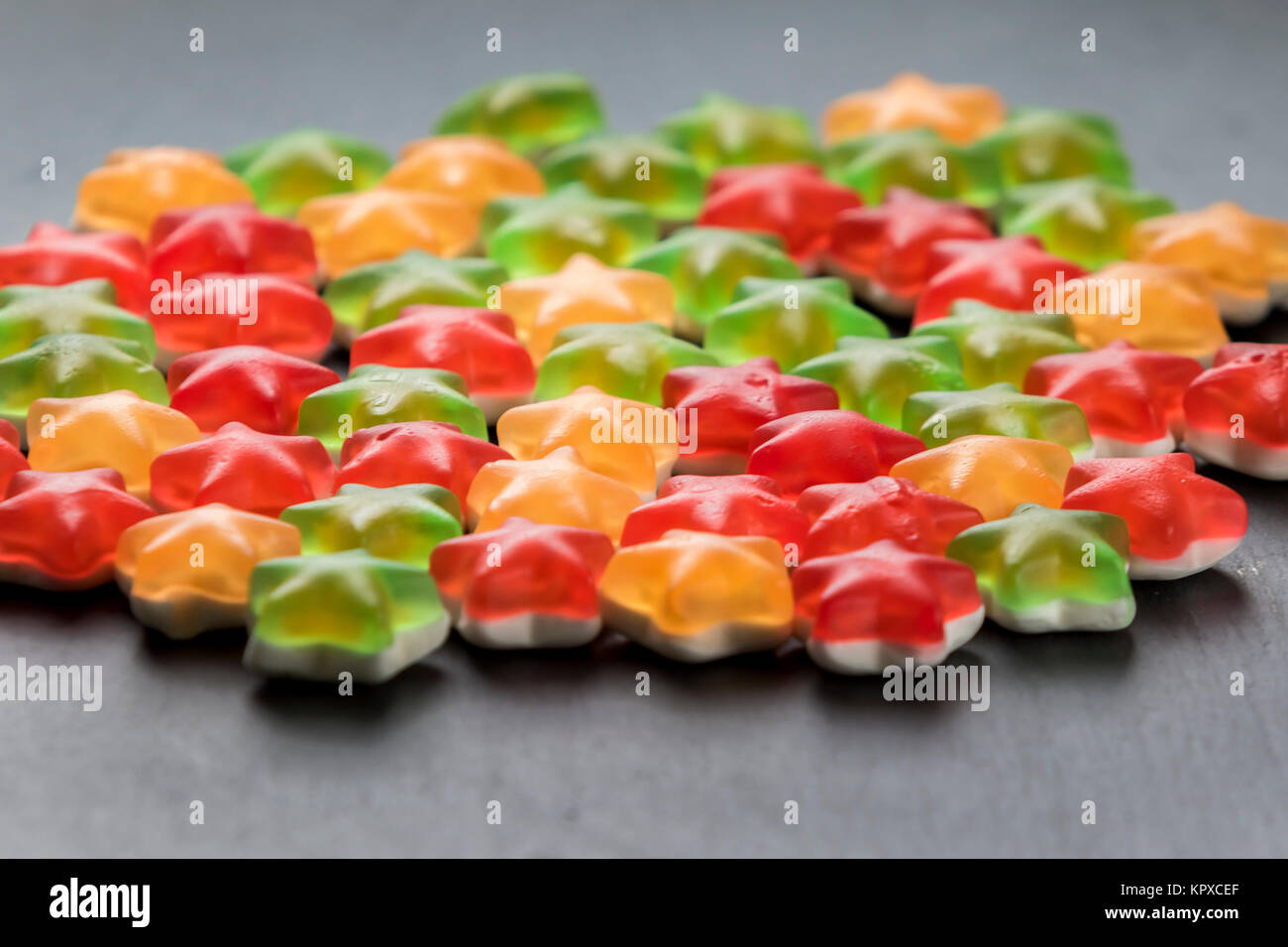 Star shape gummy candy on dark background Stock Photo - Alamy