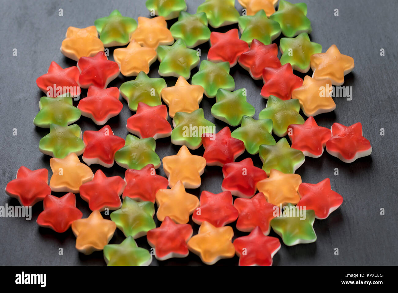 Star shape gummy candy on dark background Stock Photo - Alamy